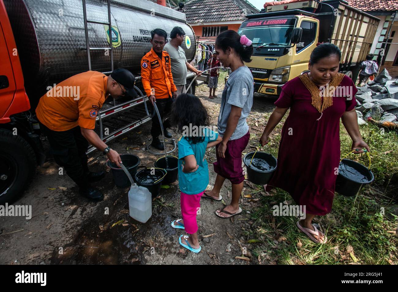 Local residents in Bogor, West Java, Indonesia, receive clean water ...