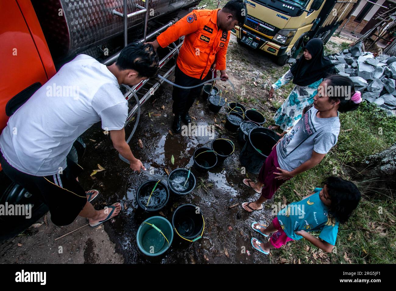 Local residents in Bogor, West Java, Indonesia, receive clean water ...