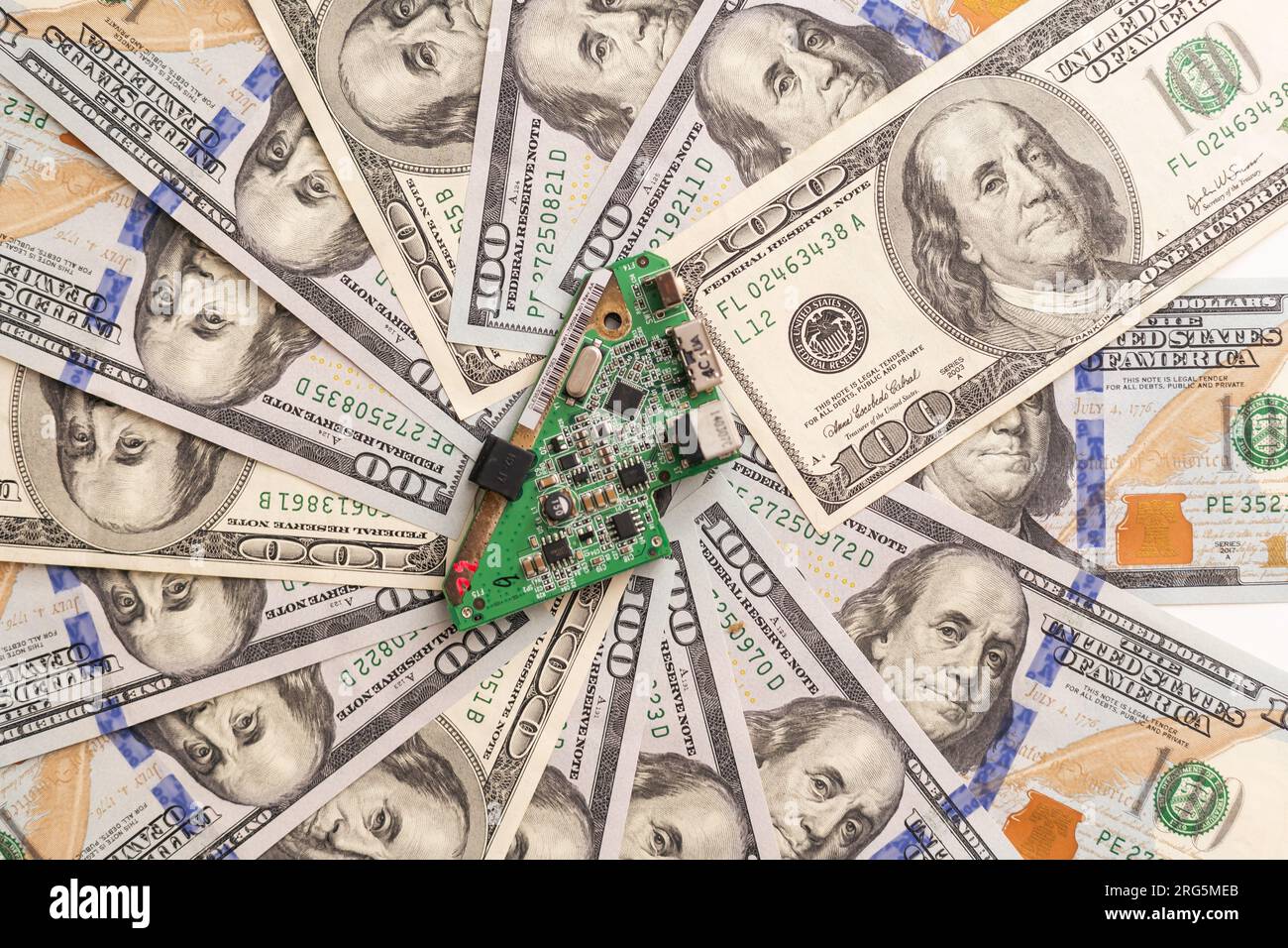 micro chip next to 100 dollar bills Stock Photo - Alamy