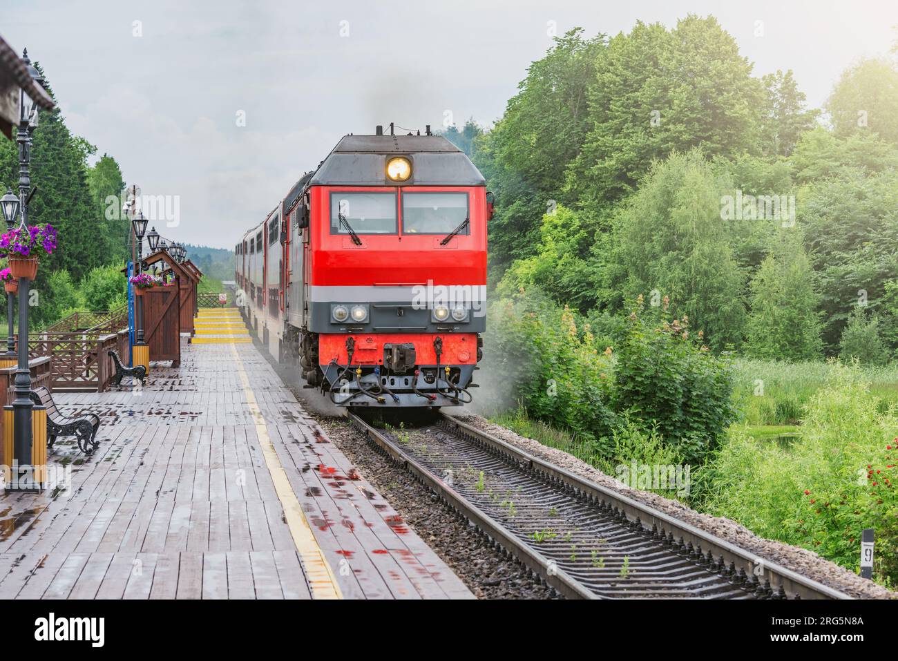 Passenger train approaches to the platform Stock Photo - Alamy