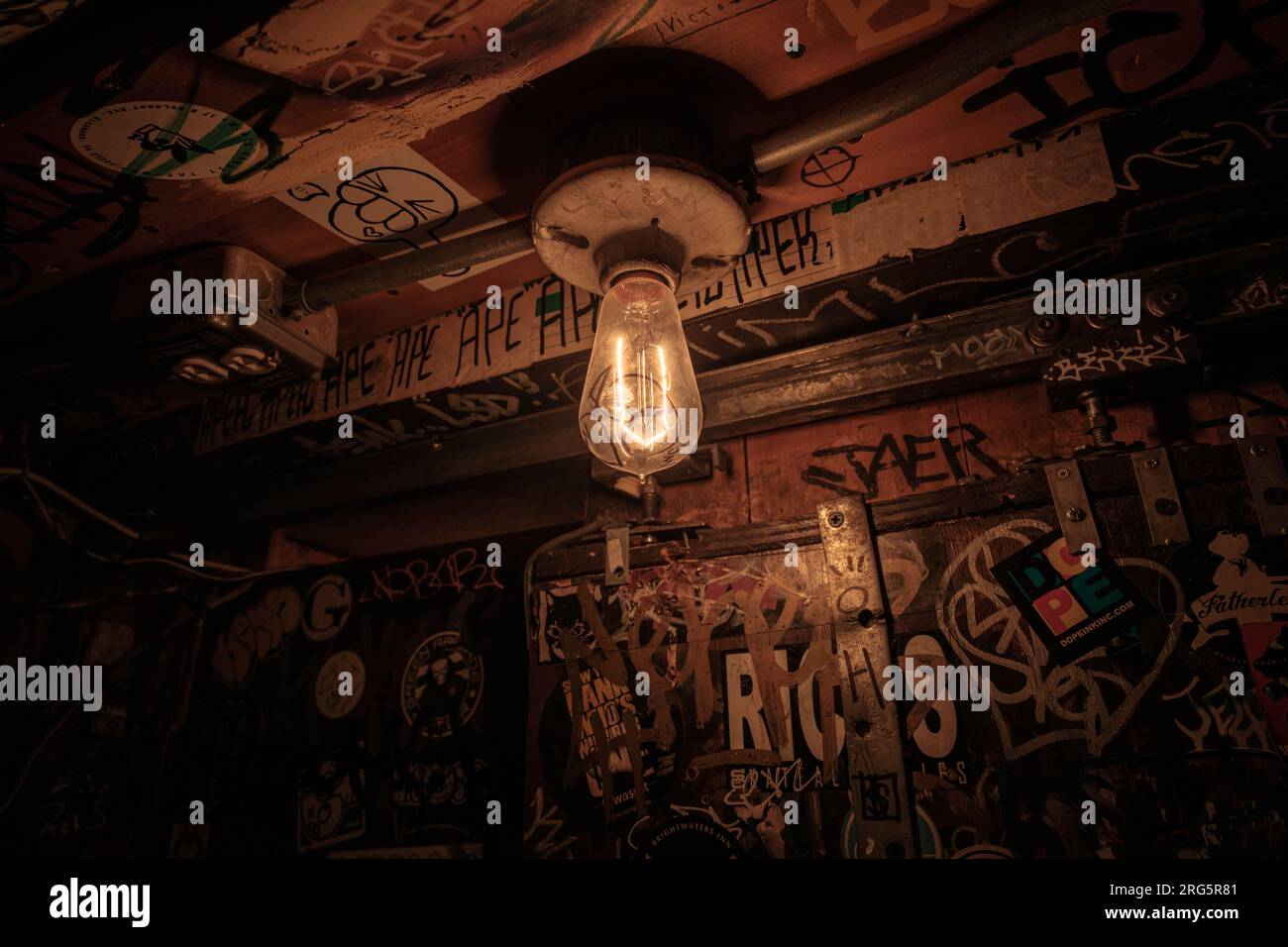 Lightbulb with graffiti and stickers at Crif Dogs, Manhattan, New York ...