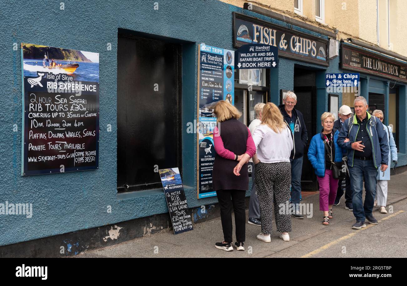 Portree Isle of Skye, Scotland, UK. 5 June 2023. Tourists reading tours ...