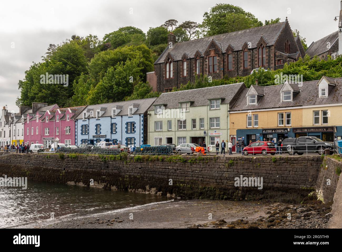 Portree, Isle of Skye, Scotland, UK. 5 June 2023. Colourful pproperties line the harbour wall in ...