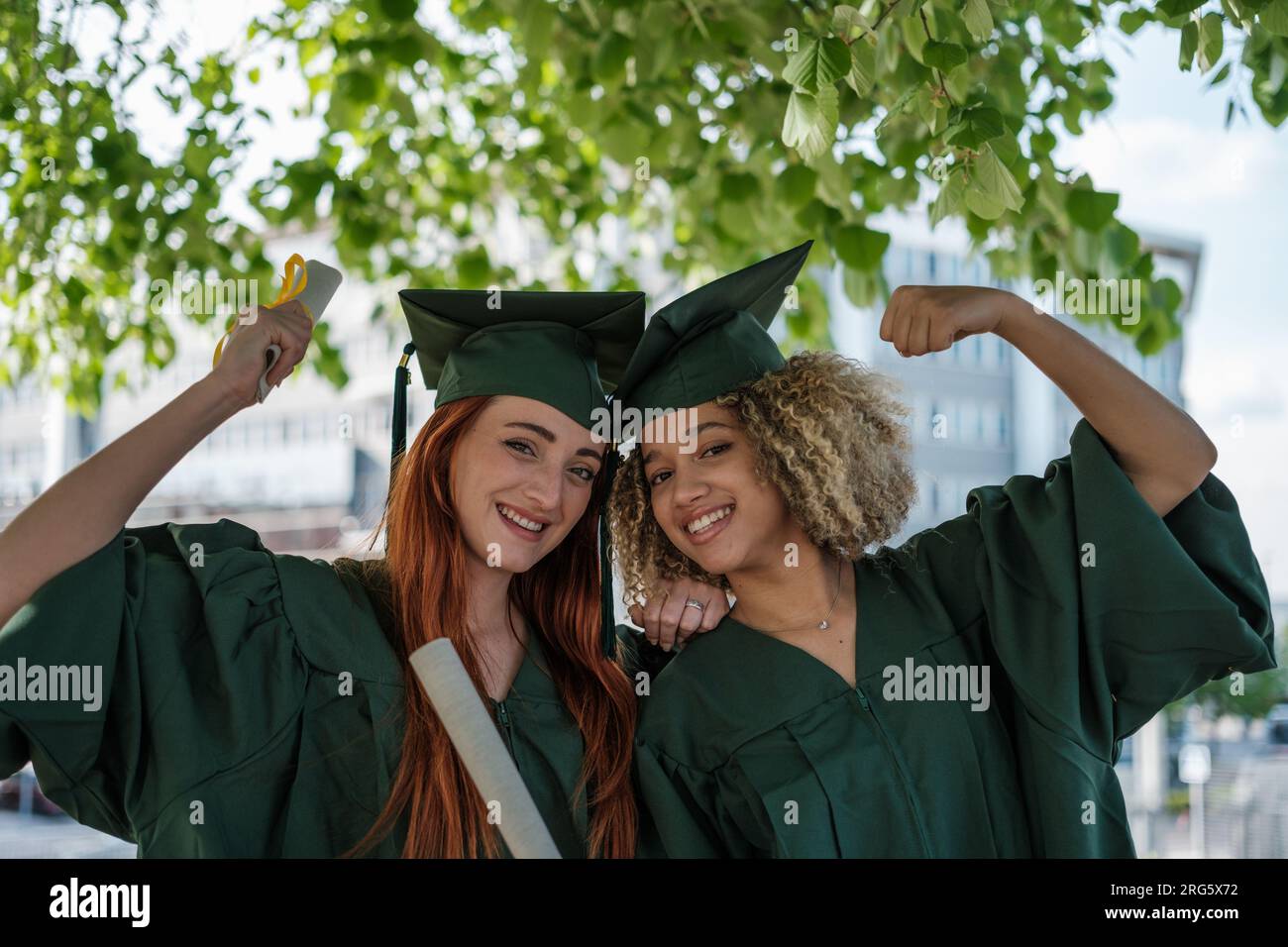 Two young students celebrating their graduation day and finishing their ...