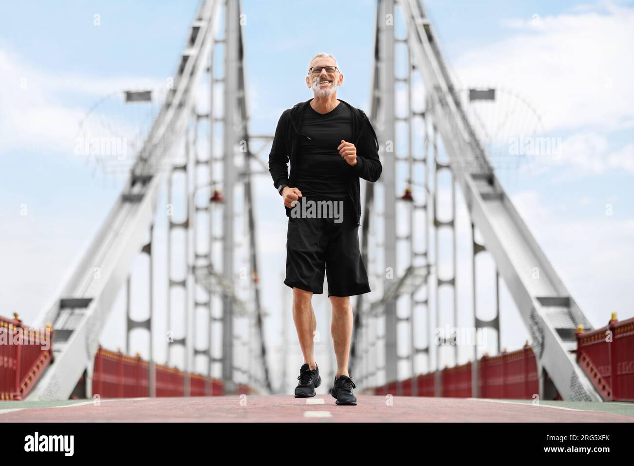 Senior man grandfather running by walking bridge, enjoying outdoor ...