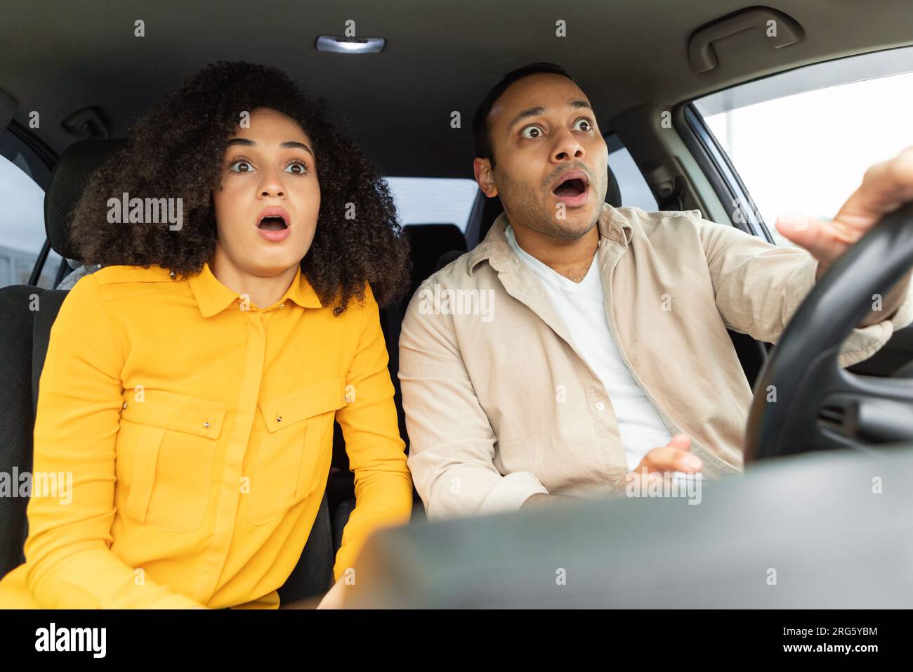 Shocked Middle Eastern couple in car having traffic accident risk Stock ...