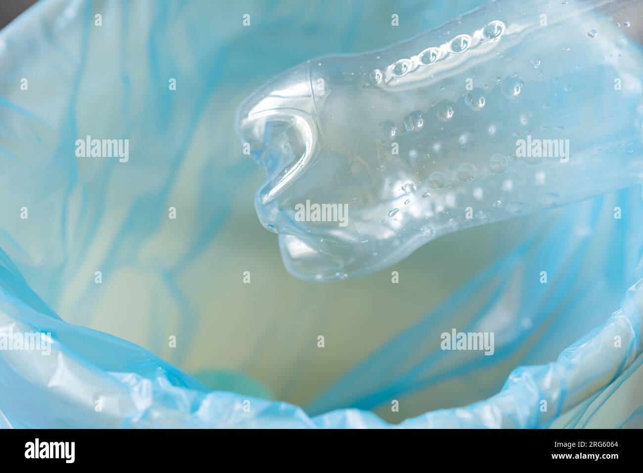 Plastic Bottle Being Disposed of in Trash Can Stock Photo - Alamy