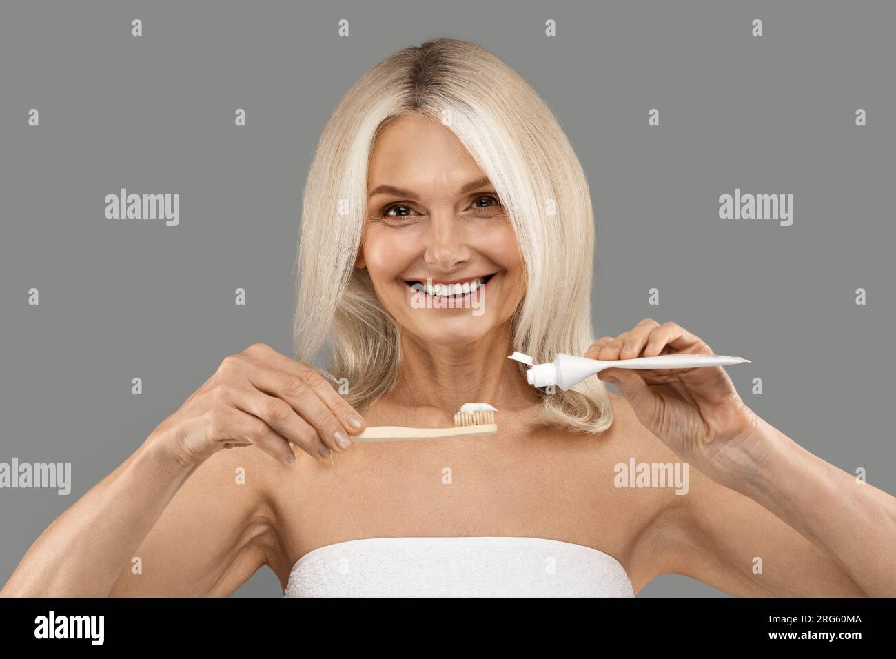 Daily Dental Care. Beautiful Mature Woman Pouring Toothpaste On ...