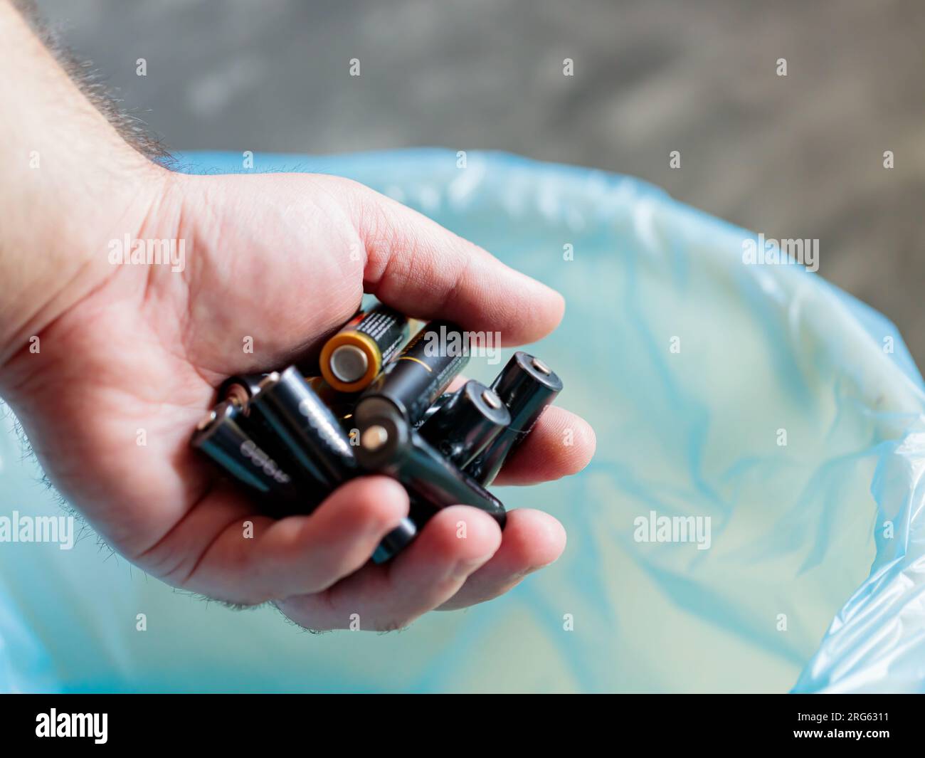 Green Living - Hand Throwing Away Used Batteries in Trash Can Stock ...