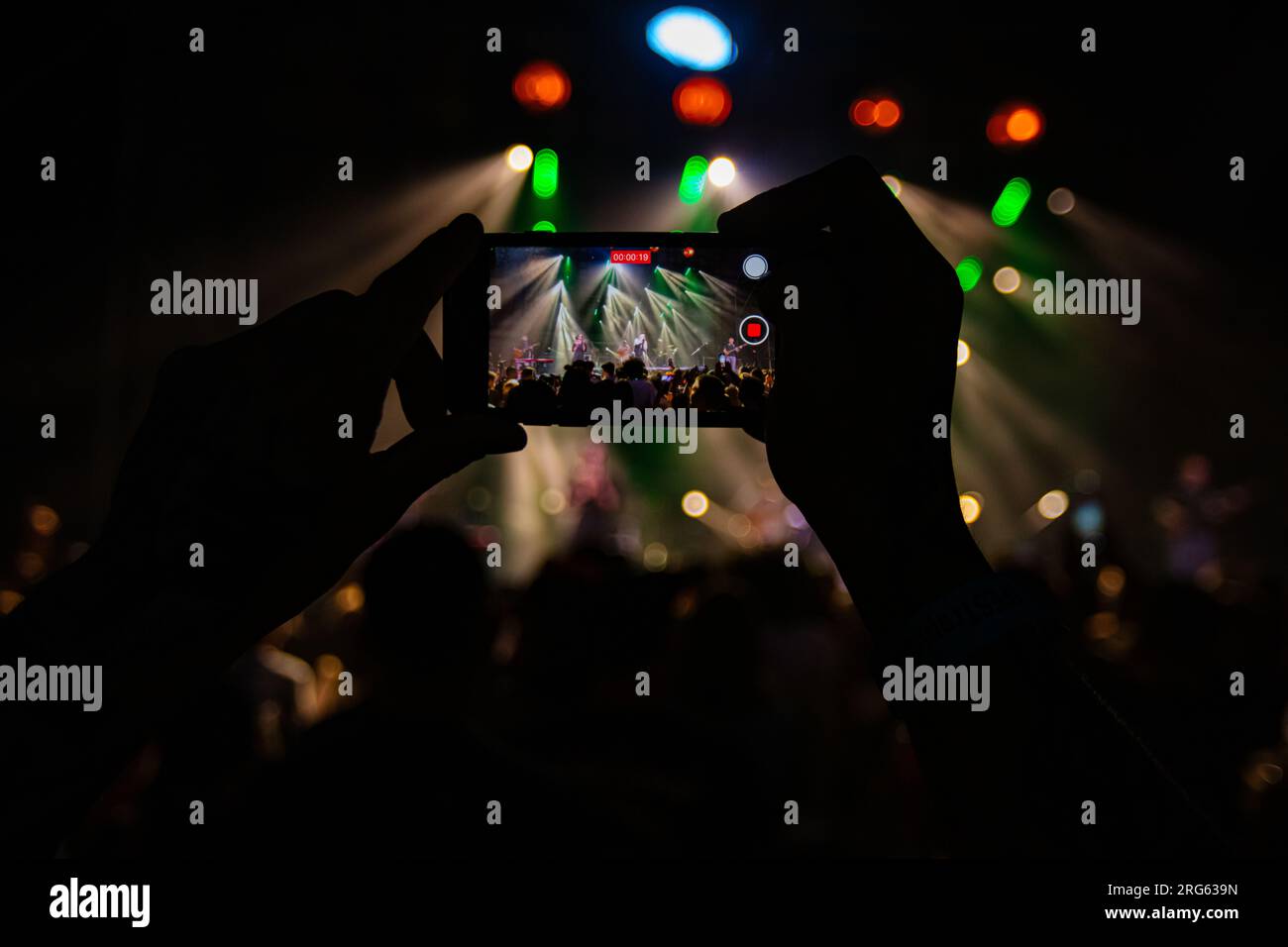 Hands holding phone and making photos on the concert. Concert ...