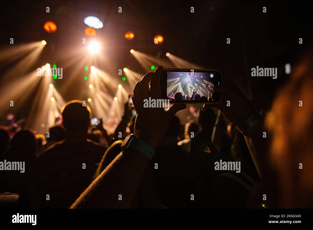 Hands holding phone and making photos on the concert. Concert ...