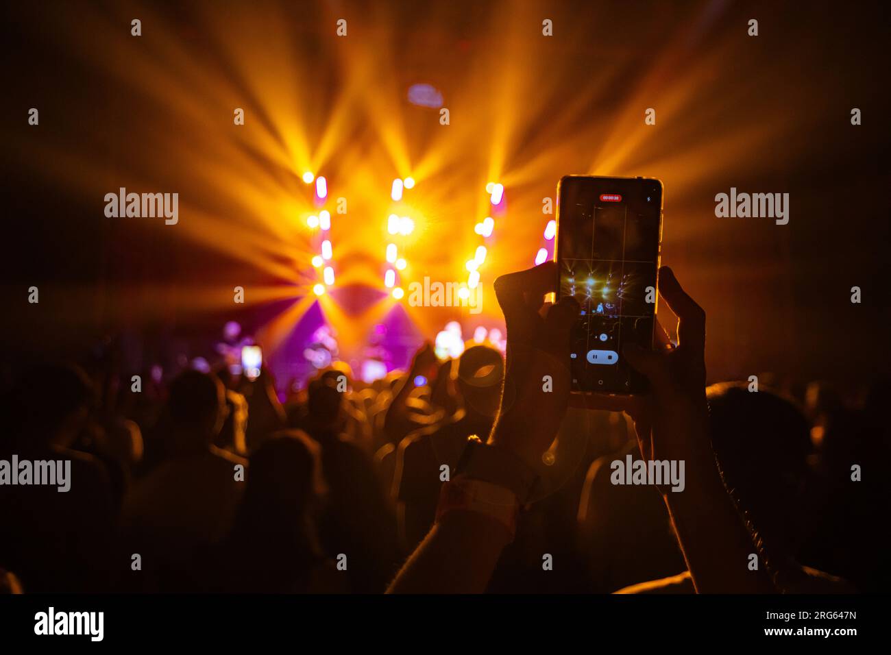 Hands holding phone and making photos on the concert. Concert ...