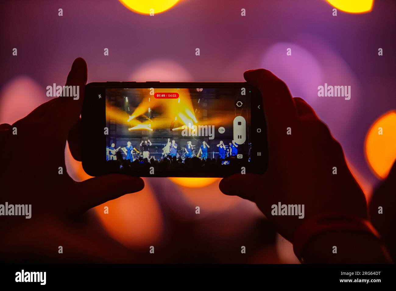 Hands holding phone and making photos on the concert. Concert ...