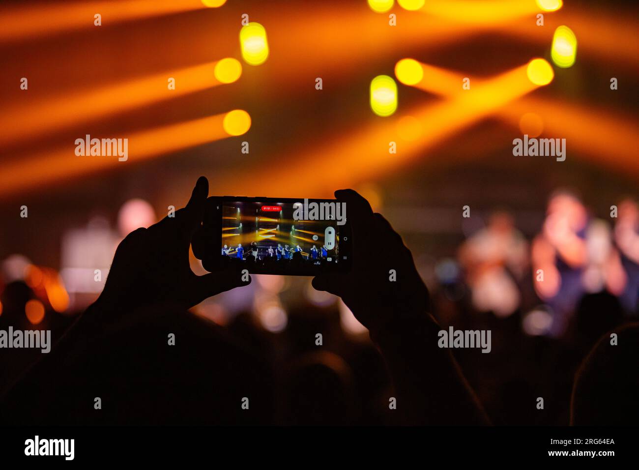 Hands holding phone and making photos on the concert. Concert ...