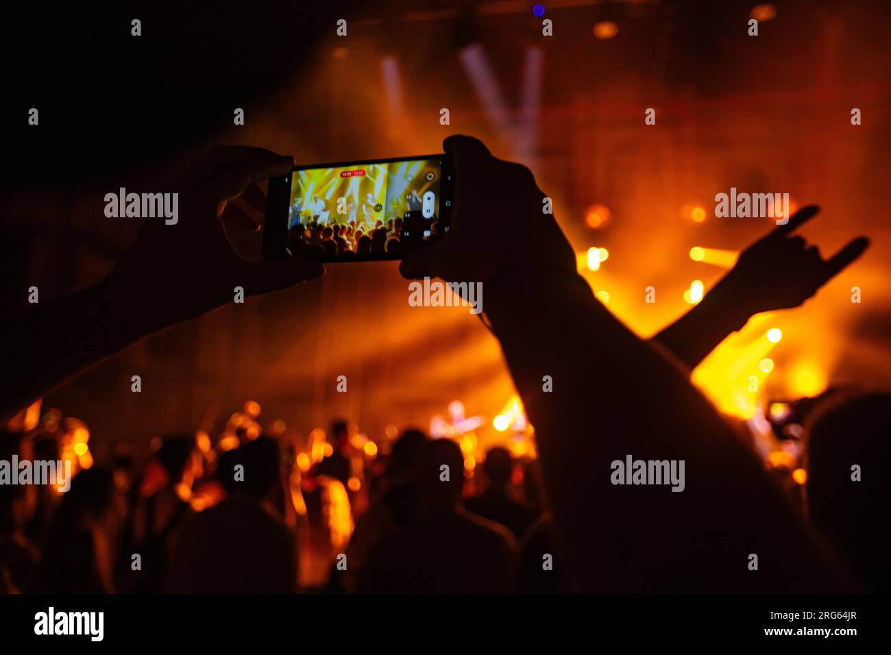 Hands holding phone and making photos on the concert. Concert ...