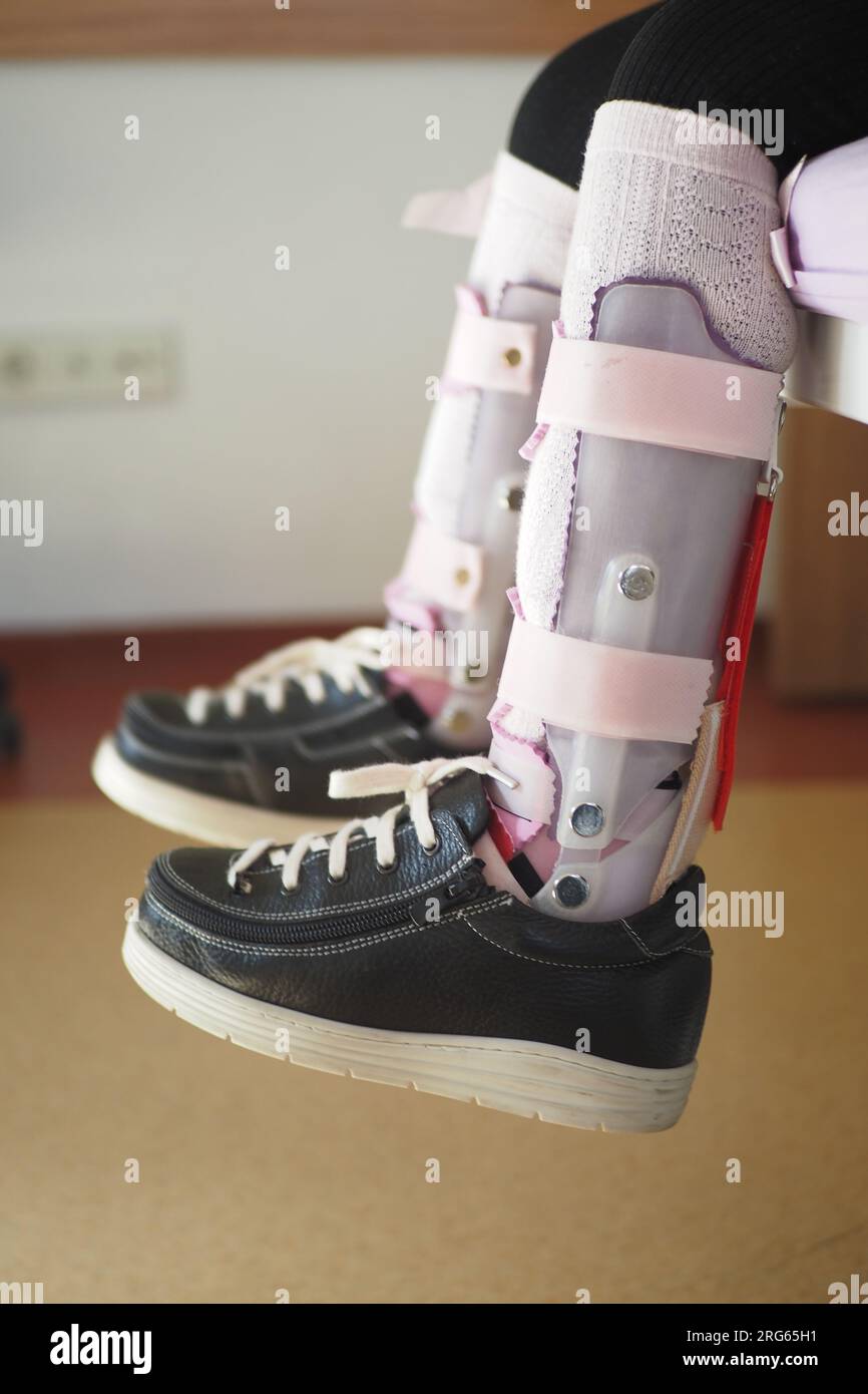Child cerebral palsy disability, legs orthosis Stock Photo - Alamy