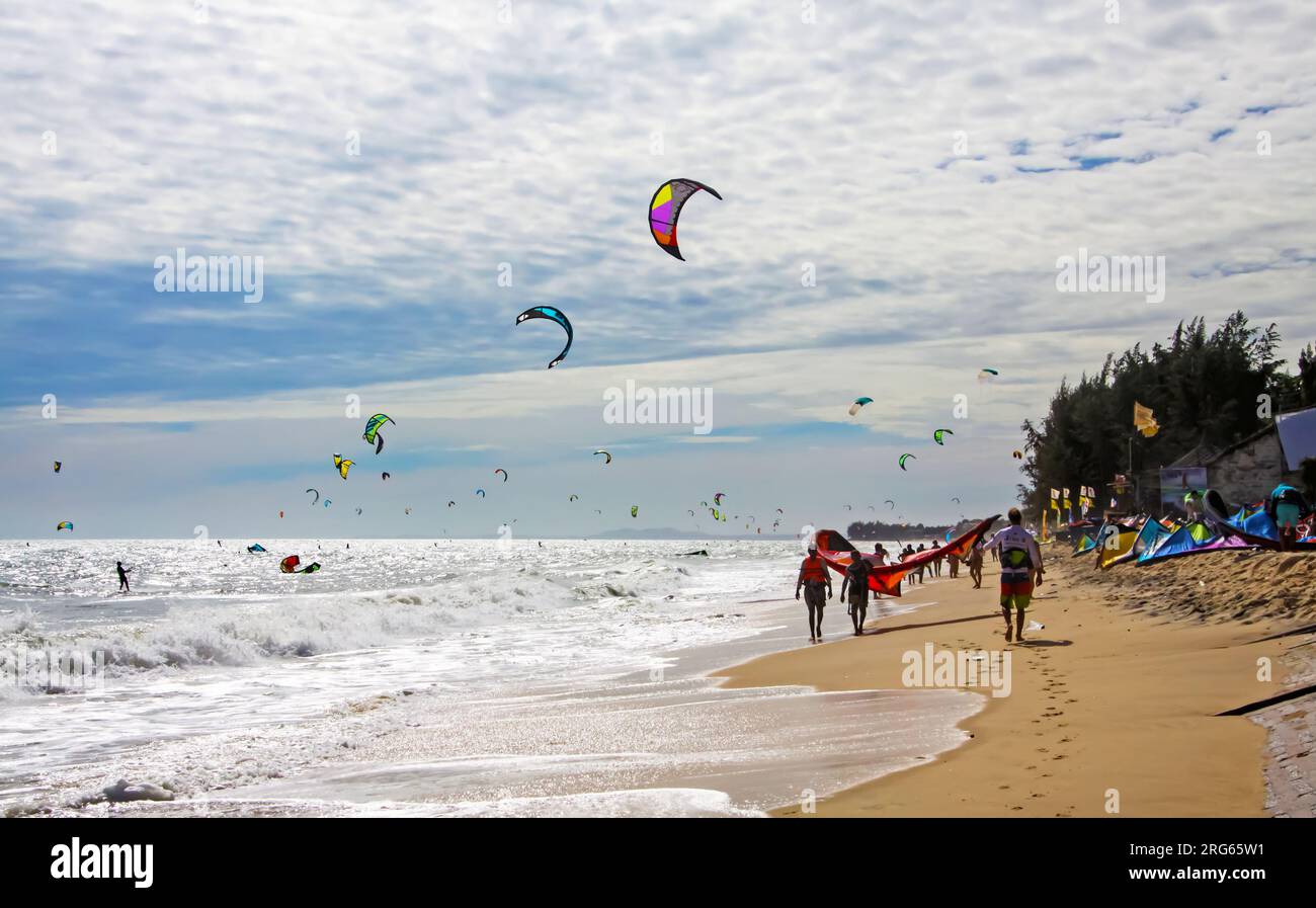 Mui Ne, Vietnam - December 9. 2016: Sand beach with many kite surfers ...