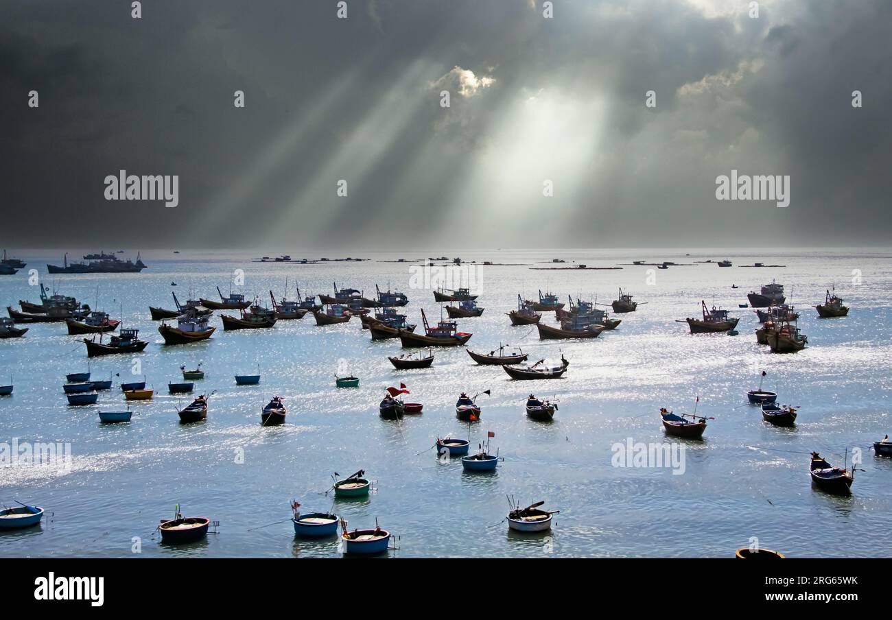Sun rays break through dark cloudy sky after thunderstorm in a ...
