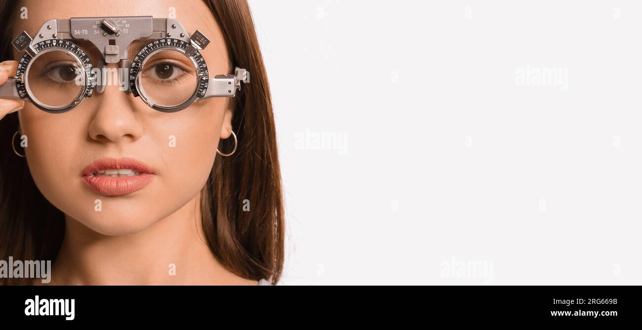 Young woman undergoing eye test on white background. Banner for design ...