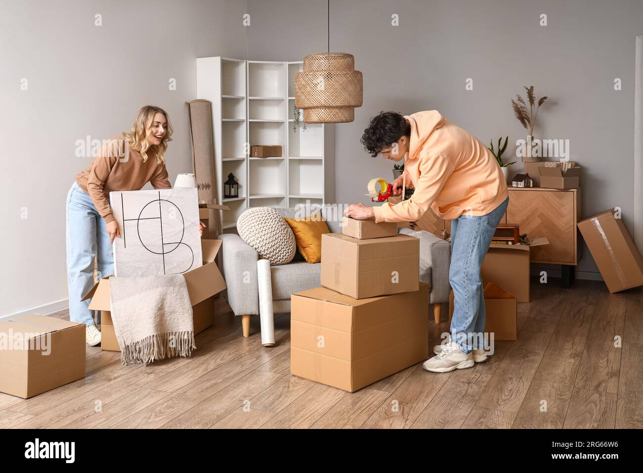 Young couple packing things in room on moving day Stock Photo - Alamy