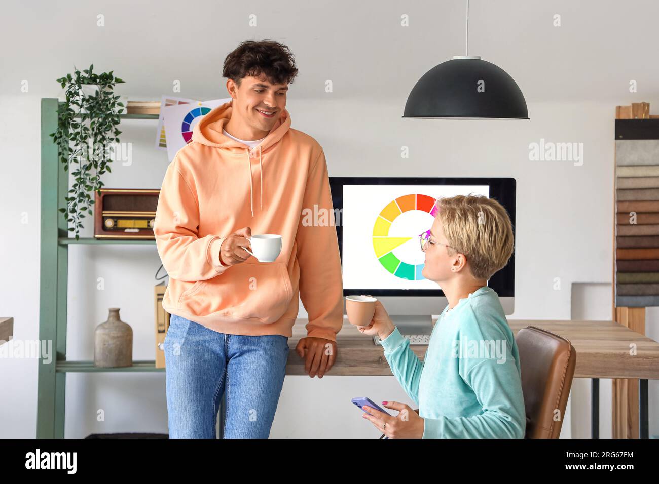 Graphic designers working in office Stock Photo - Alamy