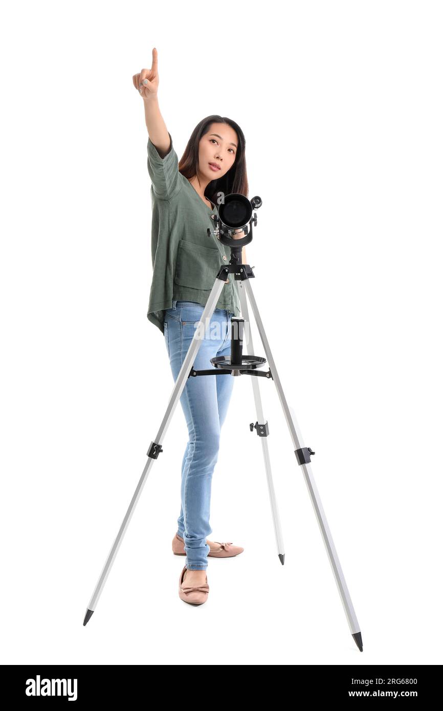 Young Asian woman with telescope pointing at something on white ...
