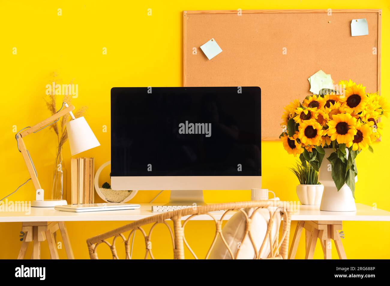 Modern workplace with computer and sunflowers in office Stock Photo - Alamy