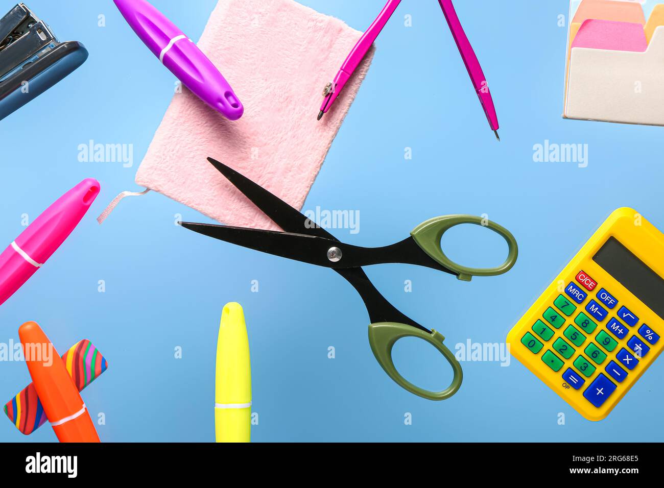 Different school supplies flying against color background Stock Photo ...