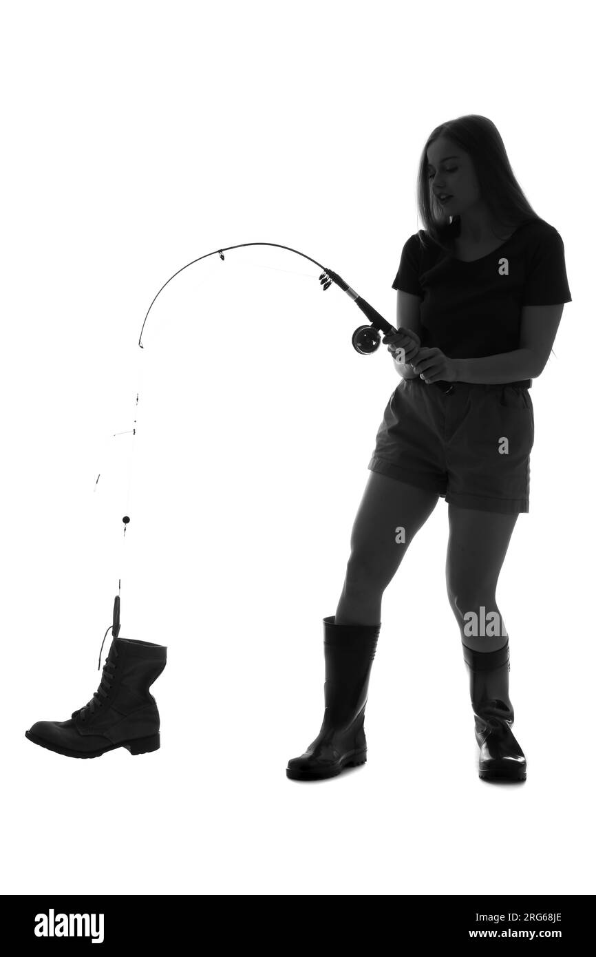 Silhouette of young woman catching shoe with fishing rod on white ...