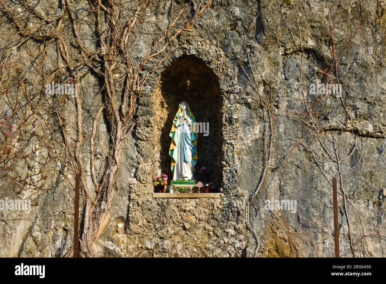 Statue of Virgin Mary in a recess carved into natural rock near ...