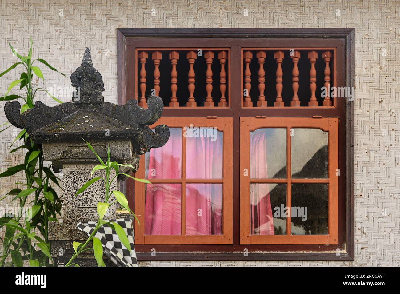 Window in traditional Balinese woven bamboo house with alter ...