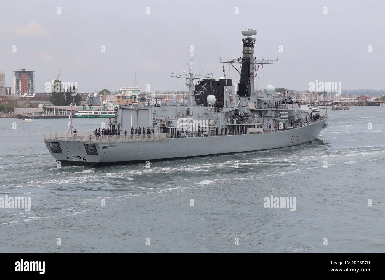 The crew of HMS IRON DUKE line the deck in ‘Procedure Alpha’ as the ...