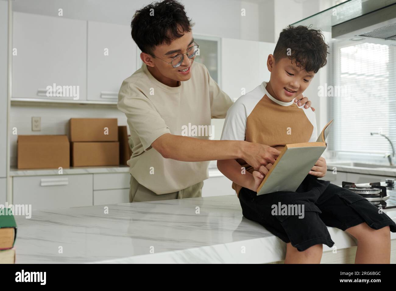 Father and son book together asian hi-res stock photography and images ...