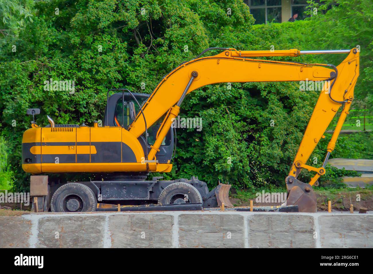 Crawler excavator front view digging on demolition site in backlight ...