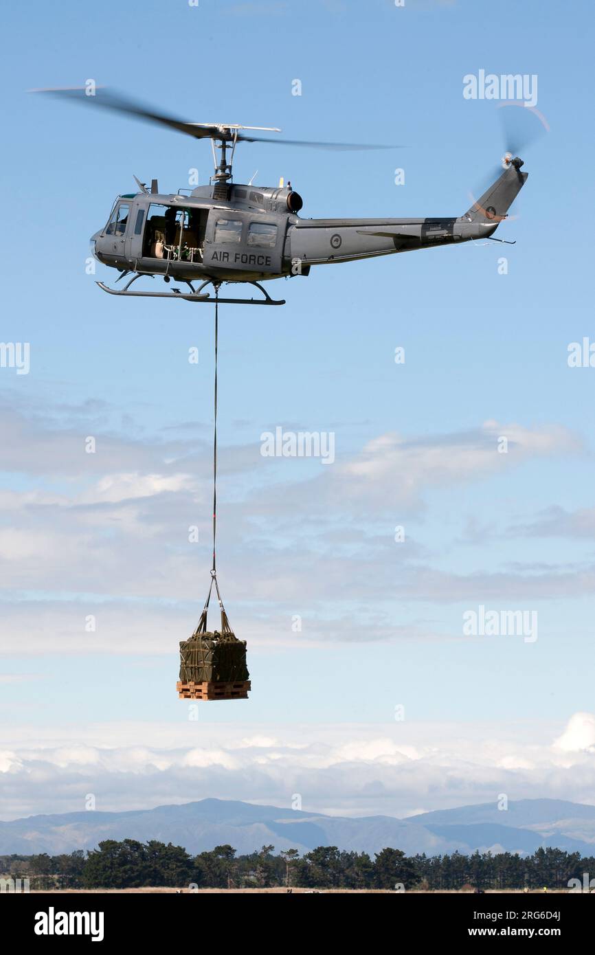 A Royal New Zealand Air Force UH-1H helicopter performing sling load ...