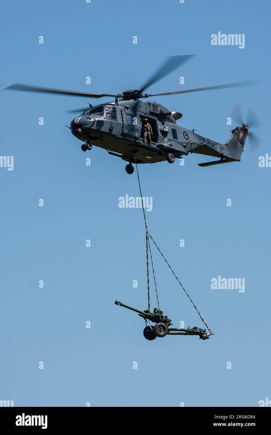 A Royal New Zealand Air Force NH90-TTH sling loading a L119 light gun 105mm howitzer, New ...