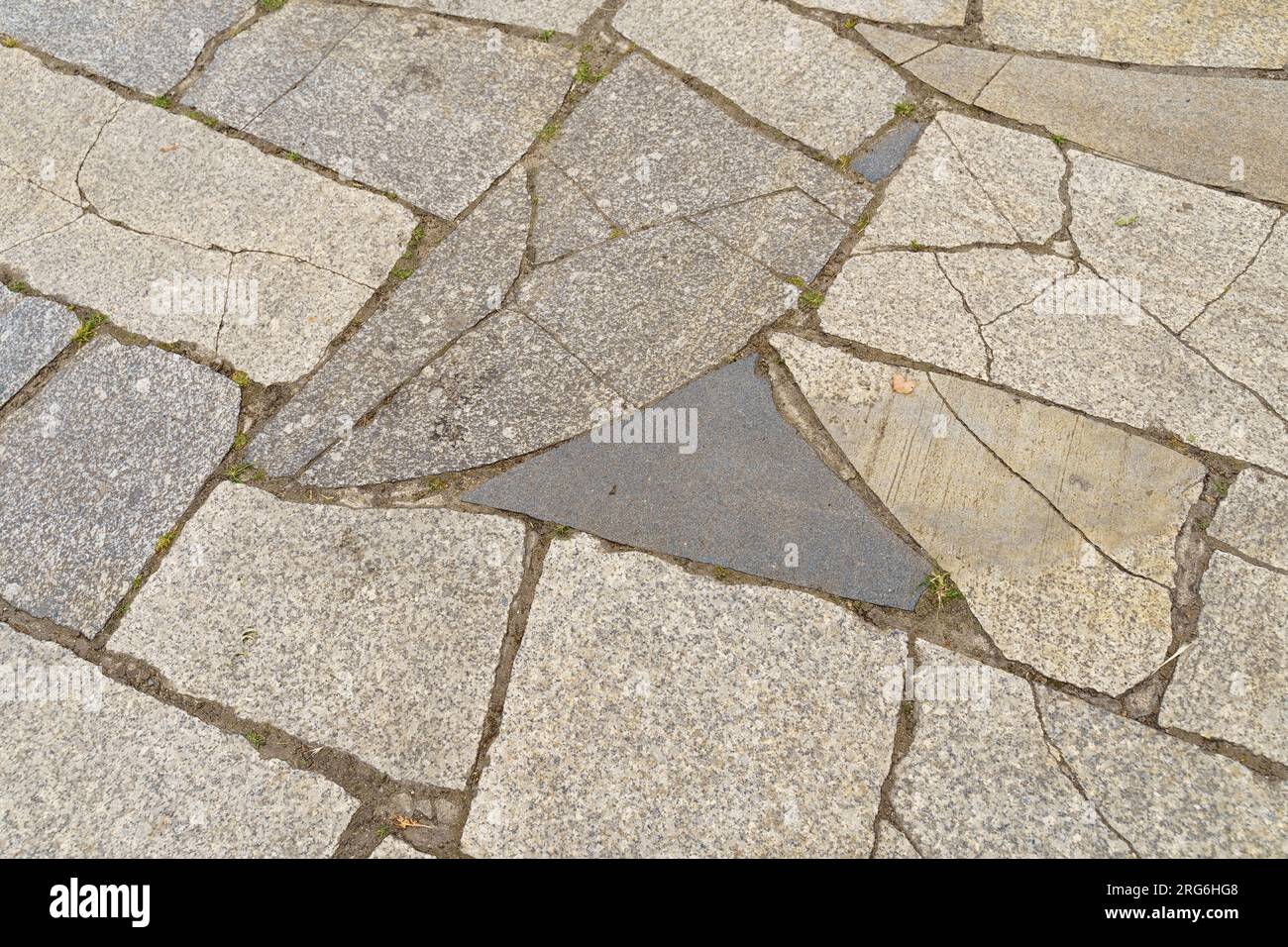 Texture of old cracked gray granite paving slabs Stock Photo - Alamy