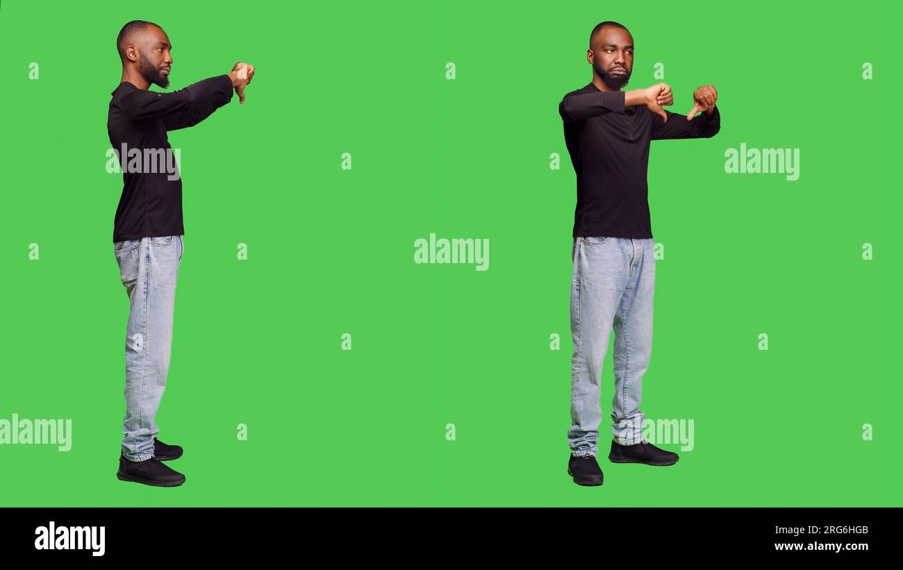 Displeased man showing thumbs down gesture on camera, doing ...