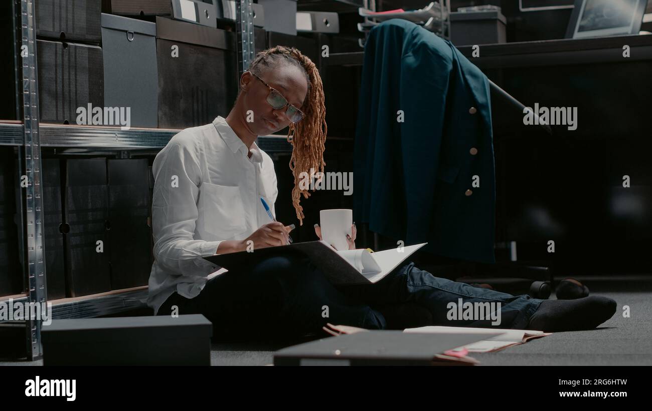 Female detective reading records on criminal case, trying to solve ...