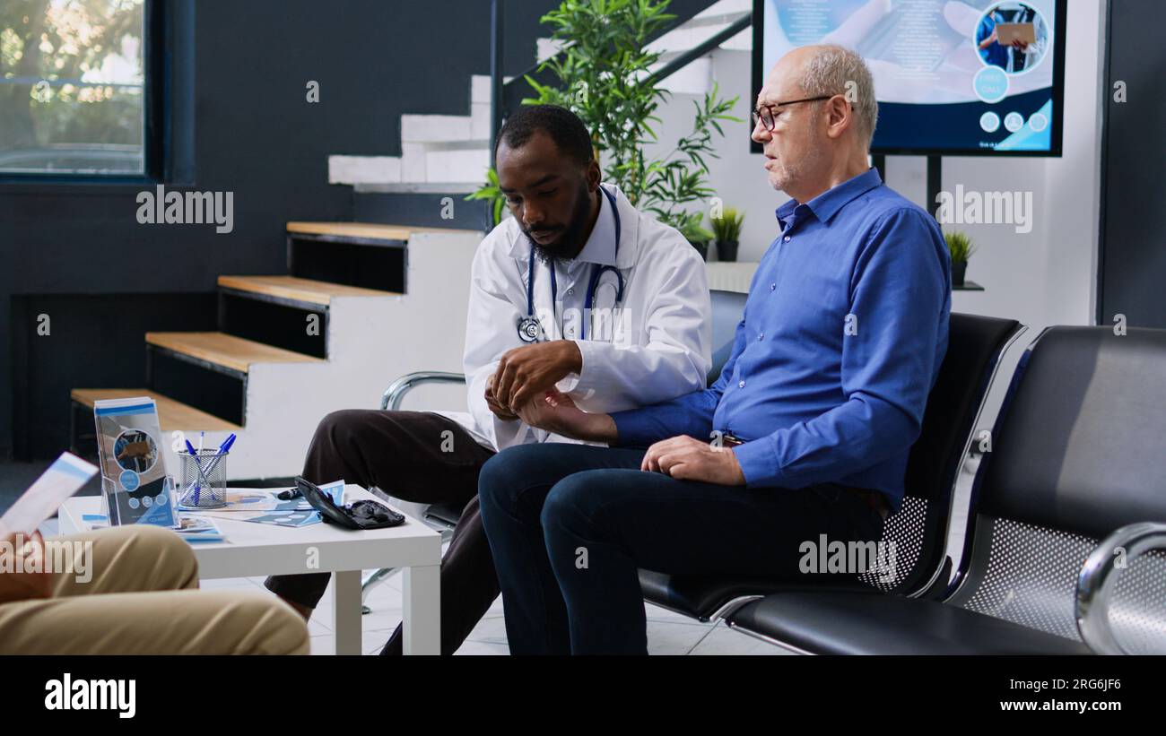 Medic doing insulin level measurement with instrument to help senior ...