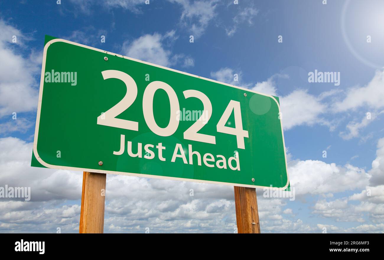 2024 Just Ahead Green Road Sign Over Clouds and Blue Sky Stock Photo ...