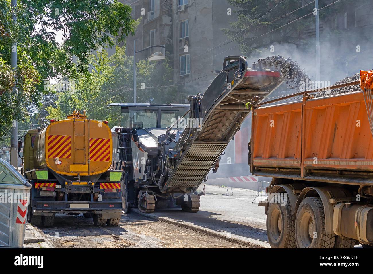 Modern. industrial paving machine removing asphalt outside on urban ...