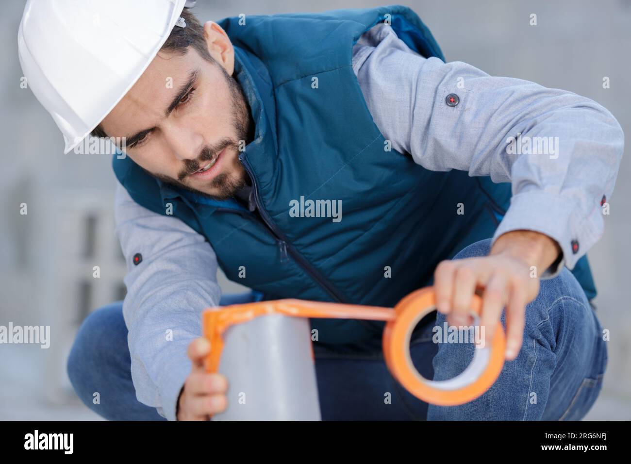 a worker measures a pipe Stock Photo - Alamy