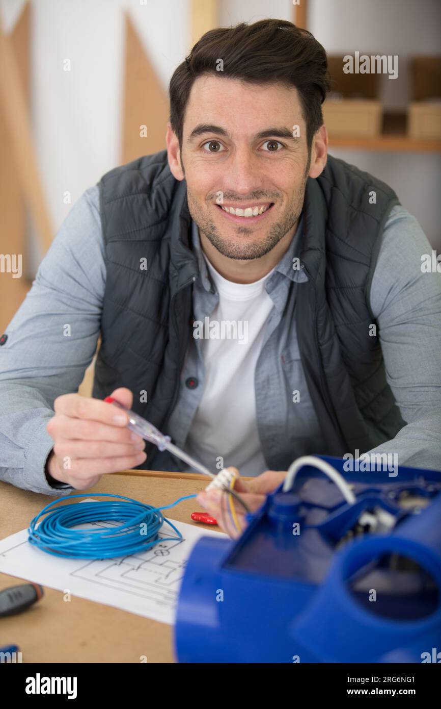 electrician using screwdriver on electrical junction box Stock Photo ...