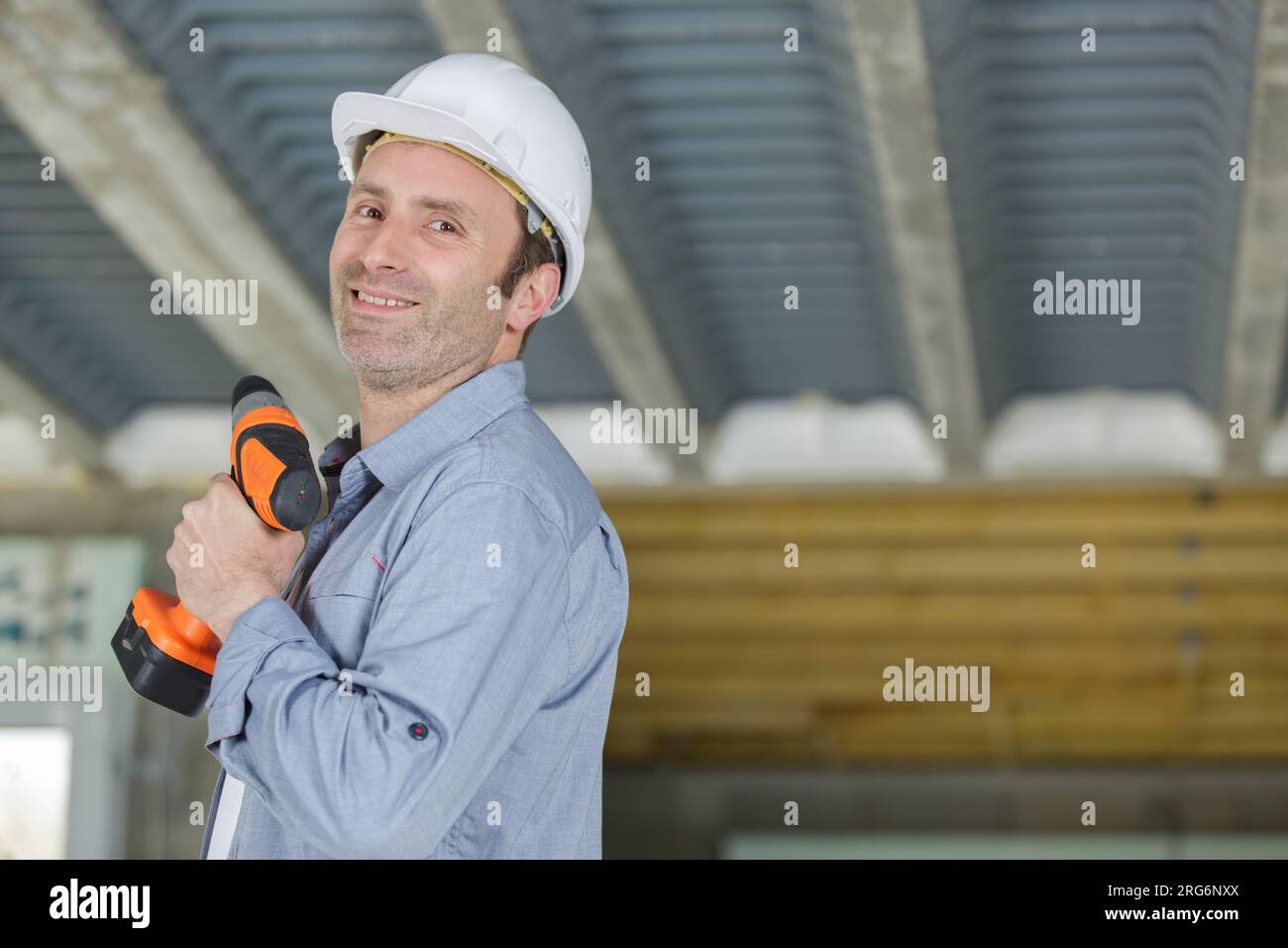 male construction worker holding cordless drill Stock Photo - Alamy