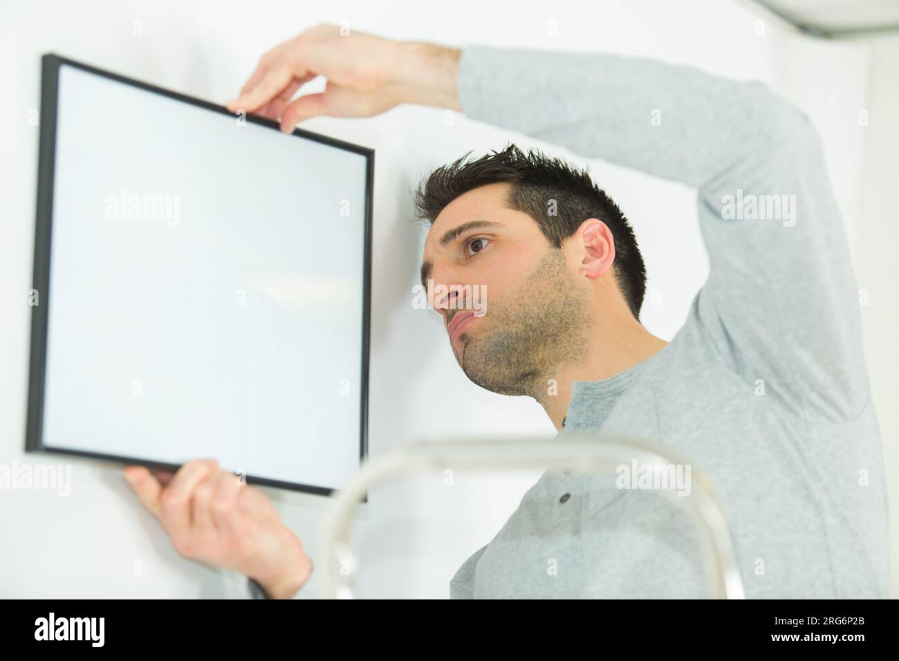 Putting up picture hi-res stock photography and images - Alamy