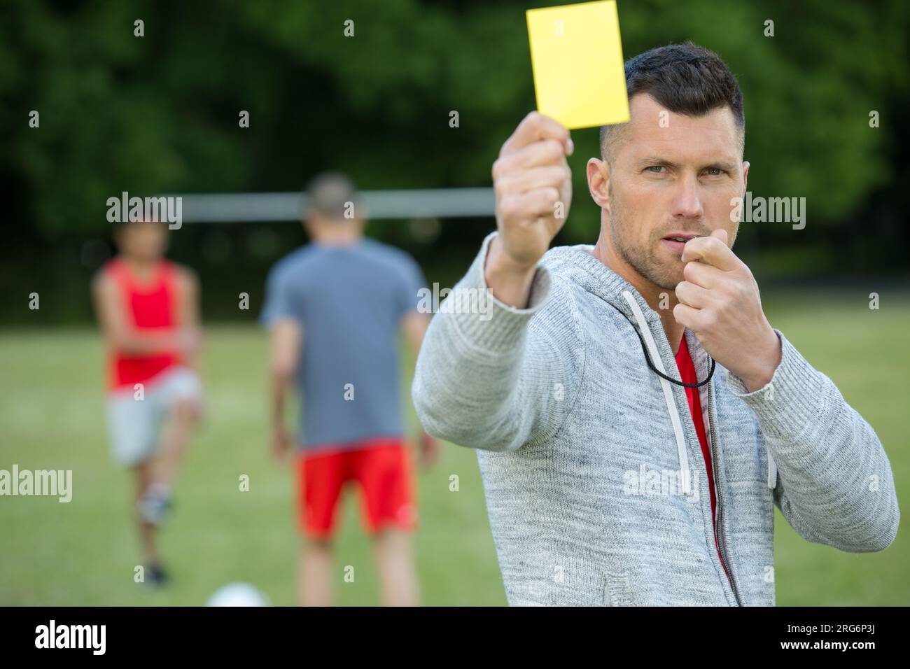 football referee showing yellow card Stock Photo - Alamy