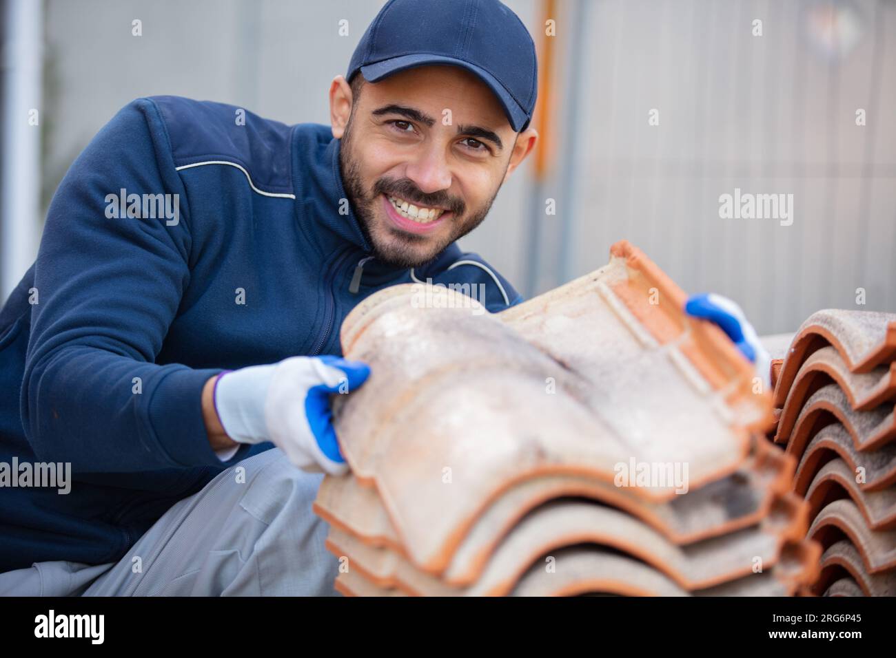 young happy man tiling on balcony ceramic tiles Stock Photo - Alamy