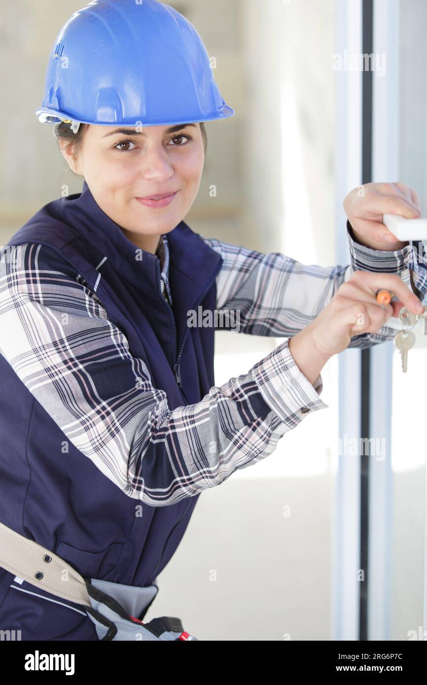 Maintenance worker fixing a window hi-res stock photography and images ...