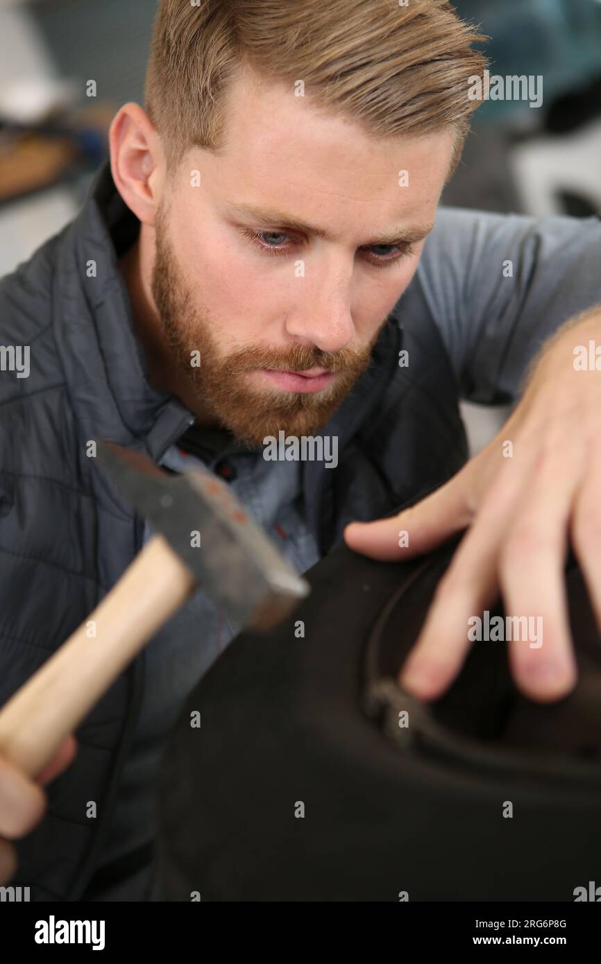 construction worker using hammer at construction site Stock Photo - Alamy